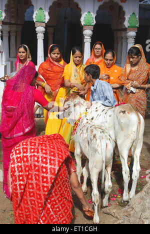 Women performing pooja of cow on Bachchabaras festival ; Jodhpur ...
