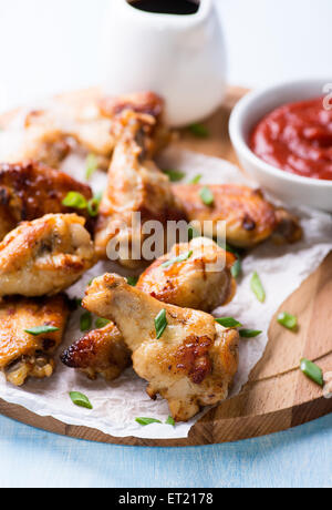 Fried chicken on a wooden board with cutlery Stock Photo - Alamy