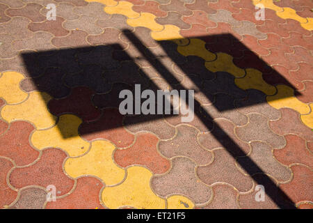 two footpath signs shadow on house wall in sun Stock Photo - Alamy