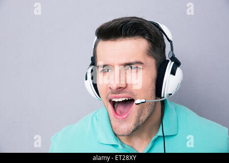 Man in headset screaming over dark studio background Stock Photo - Alamy