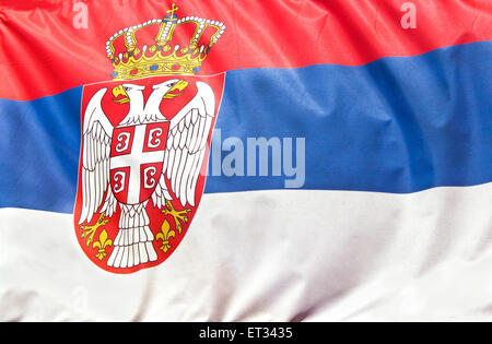 Serbian national flag on wind, outdoor, cloudy background Stock Photo ...