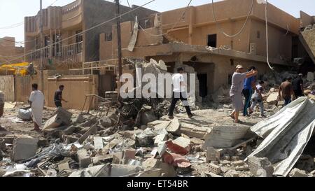 Fallujah, Iraq. 11th June, 2015. A boy stands near a damaged building ...