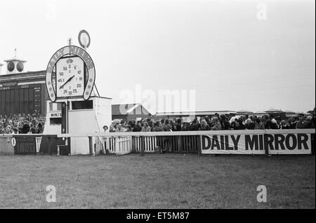 Racegoers gather at the finishing post during the Andy Capp Handicapp ...