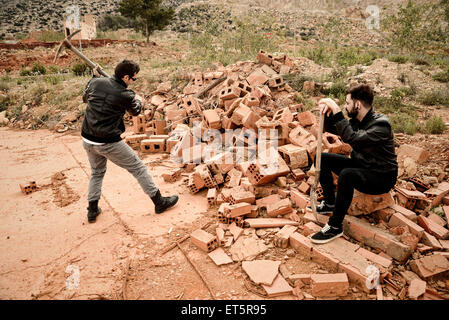 Guy working hard with a bystander doing nothing, a concept Stock Photo ...
