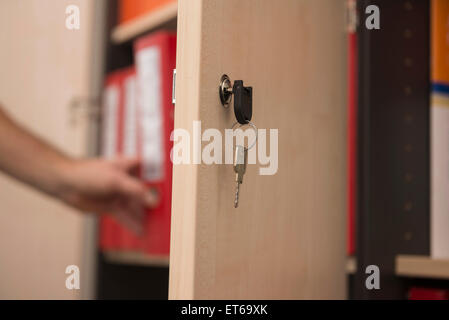 Man taking confidential file from filing cabinet, Munich, Bavaria ...