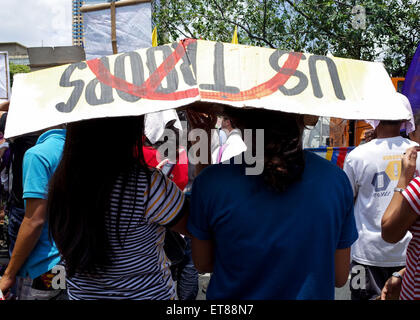 Protesters shield themselves from the sun with umbrellas as they gather ...