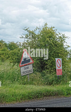 Tank crossing warning signs at roadside Stock Photo - Alamy