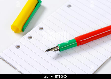 fountain pen without cap on white lined paper Stock Photo - Alamy