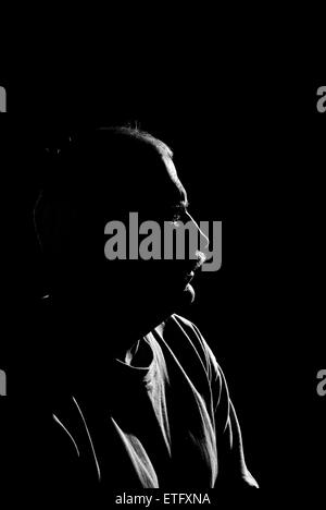 Portrait (low key, face outline) of a Caucasian man - black and white ...