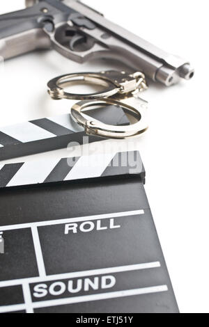 movie clapper and gun with handcuffs on white background Stock Photo ...