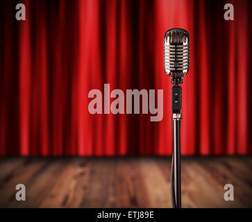 microphone on stage with red curtain background Stock Photo - Alamy