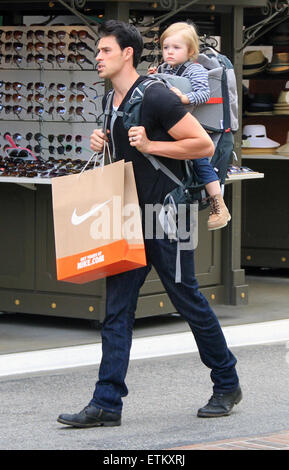 The Bold and the Beautiful soap actor, Adam Gregory carries his son, Kannon in a back carrier ...