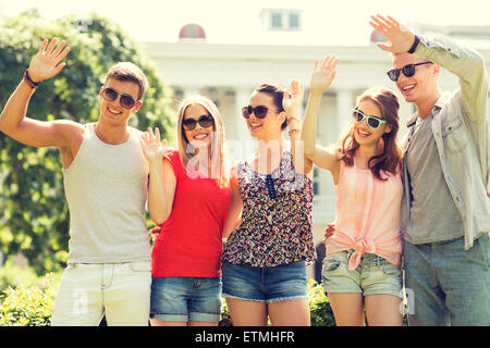 group of smiling students waving hands Stock Photo - Alamy