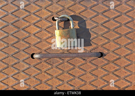 Old corroded padlock on a rusty chain hanging on a closed ancient ...