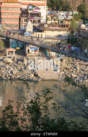 River Ganges, the famous bridge Laxman Jhula surrounded by temples and ...