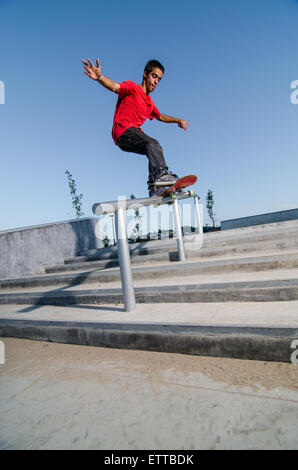Skateboarder doing a FS Feeble on rail Stock Photo - Alamy