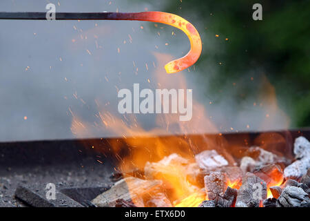 Close up of a heated iron rod on an anvil Stock Photo - Alamy