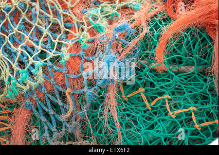 Mass of dry weathered fishing nets with mesh of different sizes a ...
