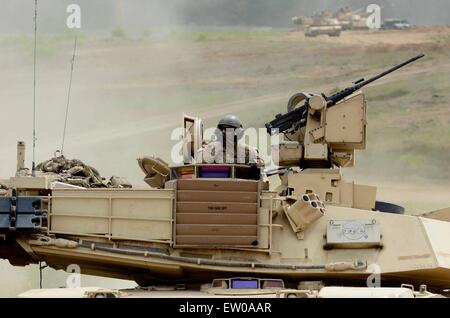 A US Army M1A2 Abrams tank fires a sabot round during annual gunnery ...