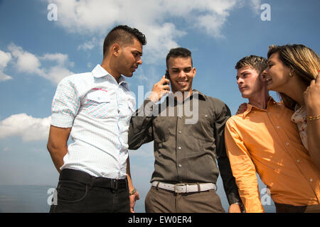 Four young Latin people having fun Stock Photo - Alamy