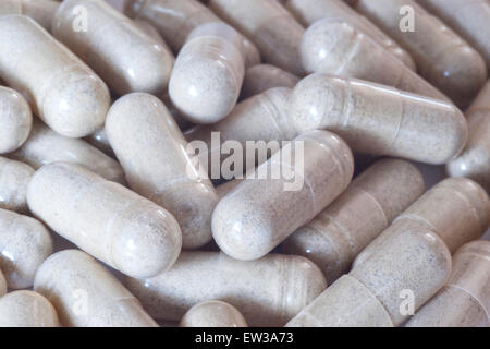Generic medication capsules containing light brown powder forming a ...