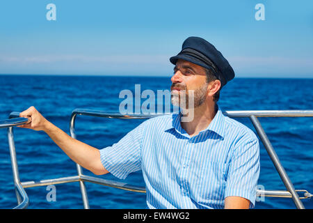 Beard sailor man sailing sea ocean in a boat with captain cap looking ...