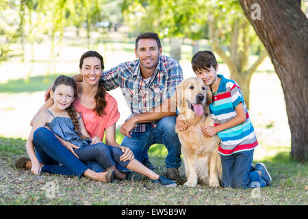 Happy family with two children and dog with drawing of dream house of ...