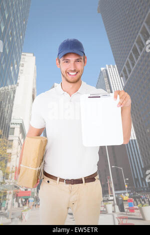 Image of happy young delivery man standing with parcel post box Stock ...