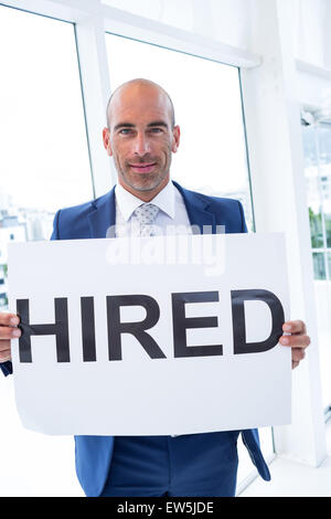 businessman holding a hired sign Stock Photo - Alamy