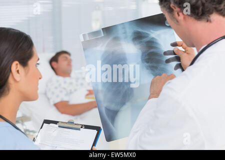 Doctors checking patients xray Stock Photo - Alamy