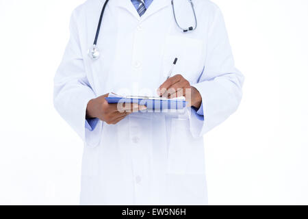 Standing doctor in white tunic writing notes Stock Photo - Alamy