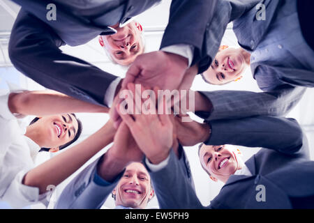 Business team standing hands together Stock Photo - Alamy