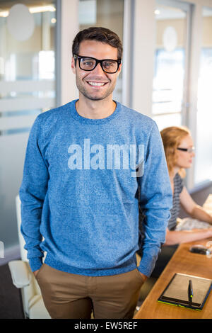A smiling handsome male posing behind a white panel isolated stock ...