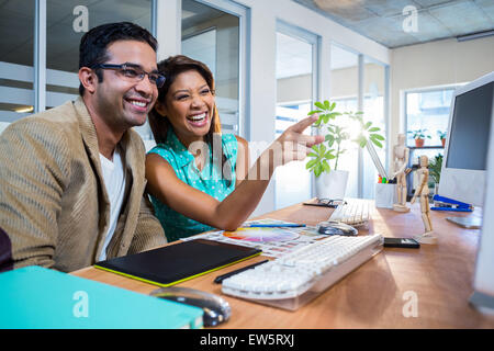 Photo of happy adult man laughing and showing funny thing on mobile ...
