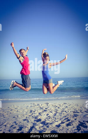 Young couple jumping, beautiful sea view on background Stock Photo - Alamy