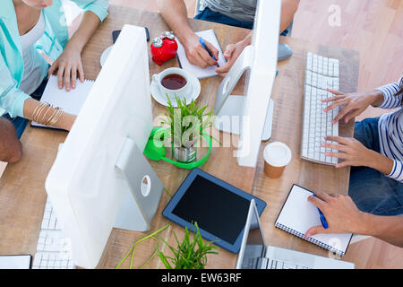 Businessman in headphones writing in notebook while sitting at ...