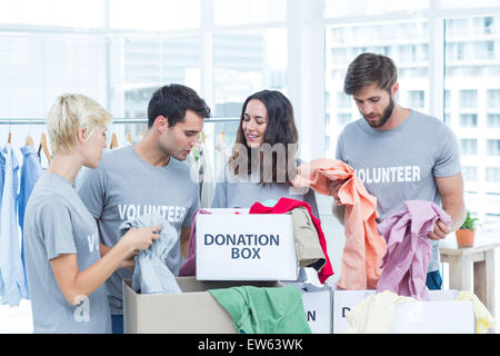 Volunteers separating donation stuffs Stock Photo - Alamy