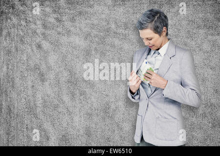 Composite image of businesswoman taking bribe Stock Photo - Alamy