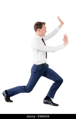 A businessman pushing something Stock Photo - Alamy