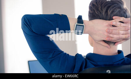 Rear view of businessman wearing smartwatch Stock Photo - Alamy