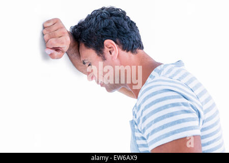 Sad man leaning his head against a wall Stock Photo - Alamy