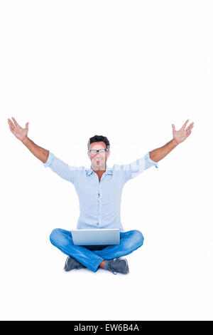 Man cheering with laptop computer and arms raised winning happy. Young ...
