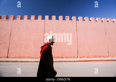 Local man wearing long-hooded cloak known as a djellaba, worn by both ...