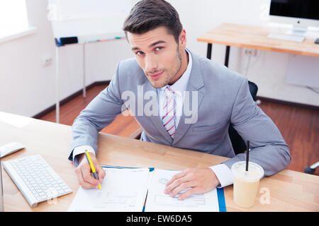 Businessman signing a document in office (Lorem ipsum text used Stock ...