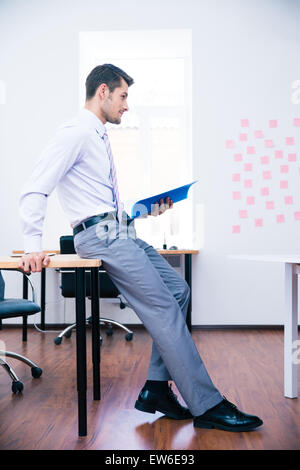 Pensive handsome man leaning on the table at home Stock Photo - Alamy