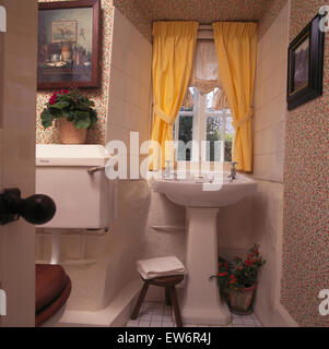 Pedestal basin in nineties bathroom with large wooden beam Stock Photo ...