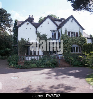 Exterior of a traditional white painted Victorian house with pots of ...