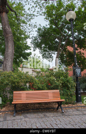 Bench under lamp in city park Stock Photo - Alamy