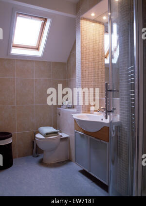 Velux window in modern attic bathroom with limestone floor tiles and ...