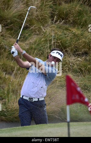 Bubba Watson hits out of a bunker on the first hole during the first ...